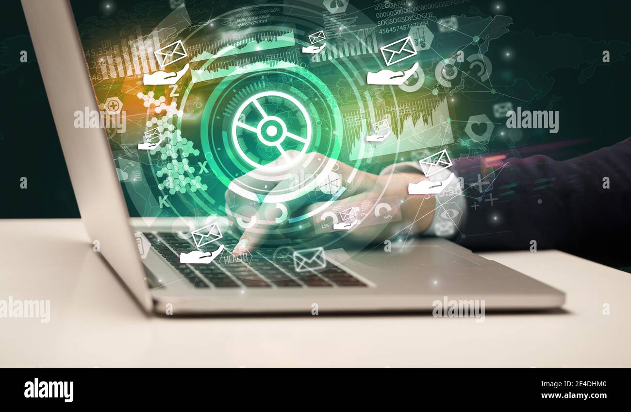 Business hand typing on a modern laptop with disk icon coming out from ...