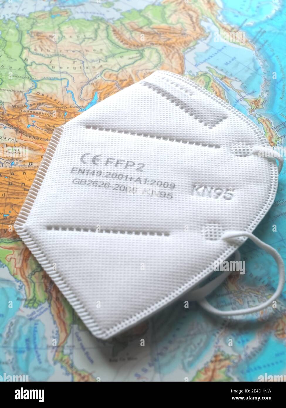 A single FFP2 face mask on a map as a symbol for flight restrictions ...