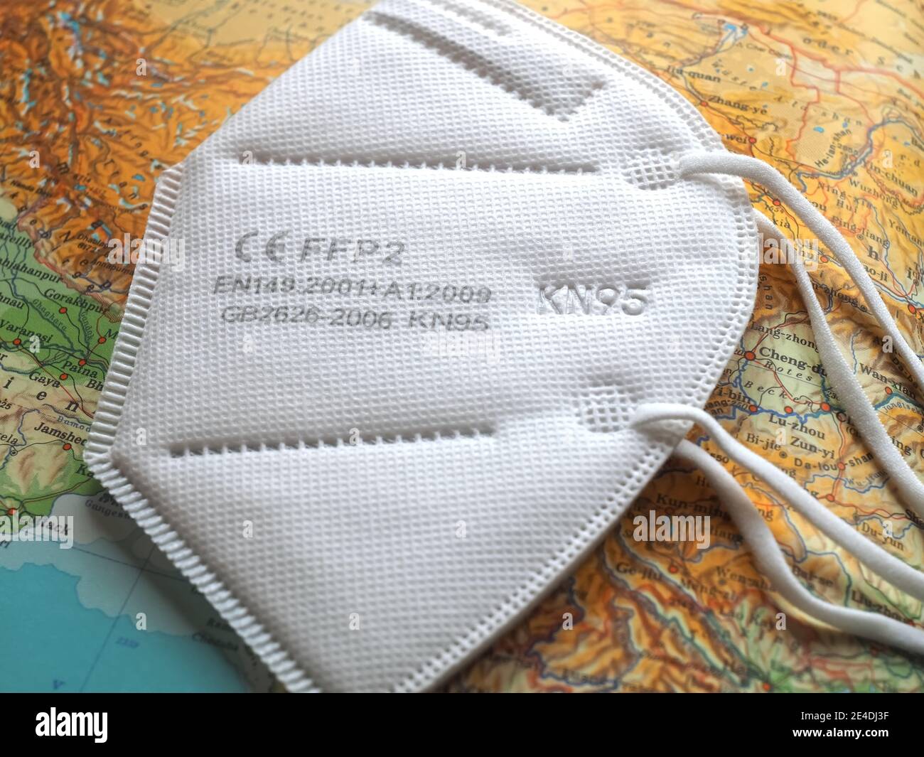 A single FFP2 face mask on a map as a symbol for flight restrictions ...