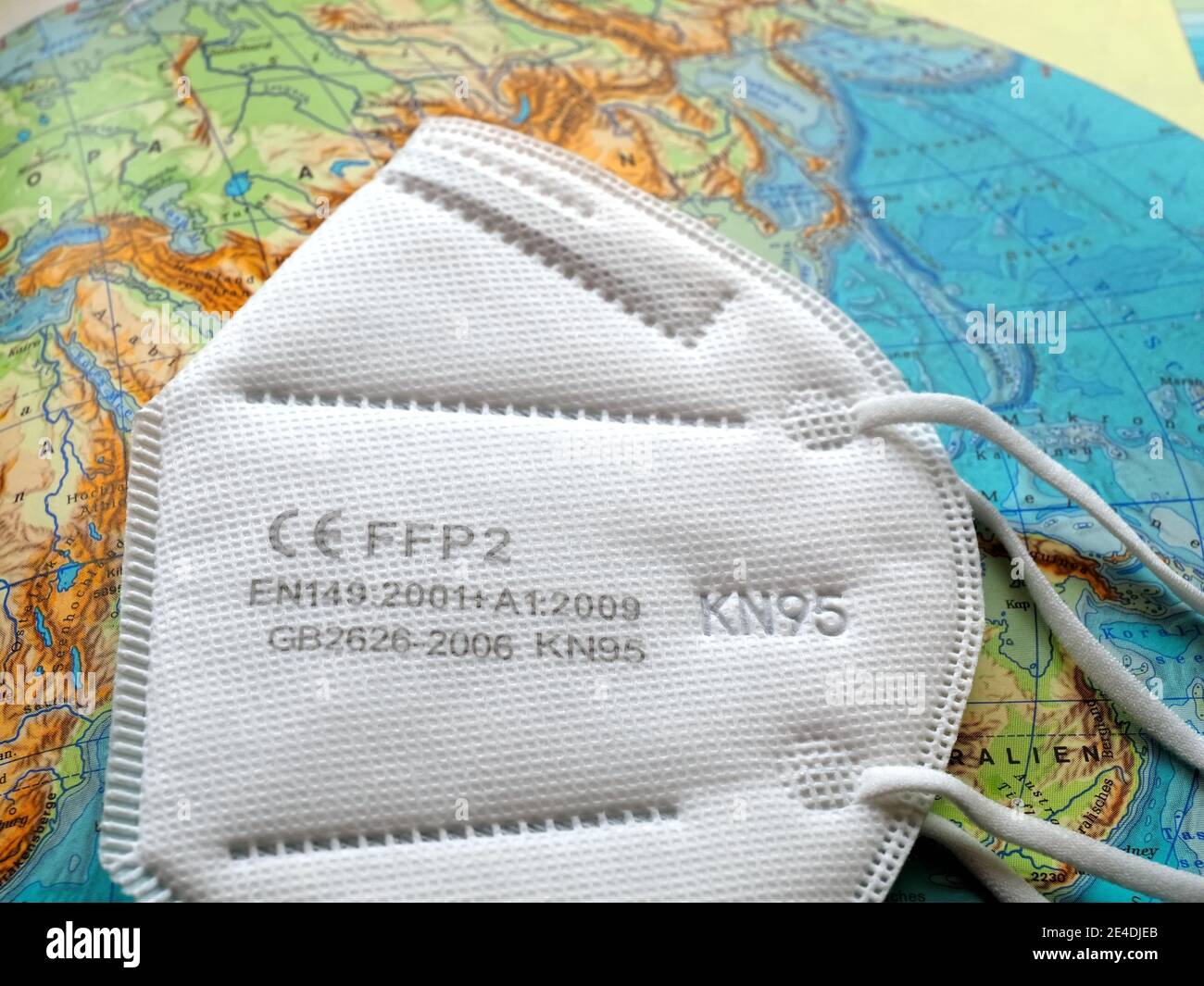 A single FFP2 face mask on a map as a symbol for flight restrictions ...