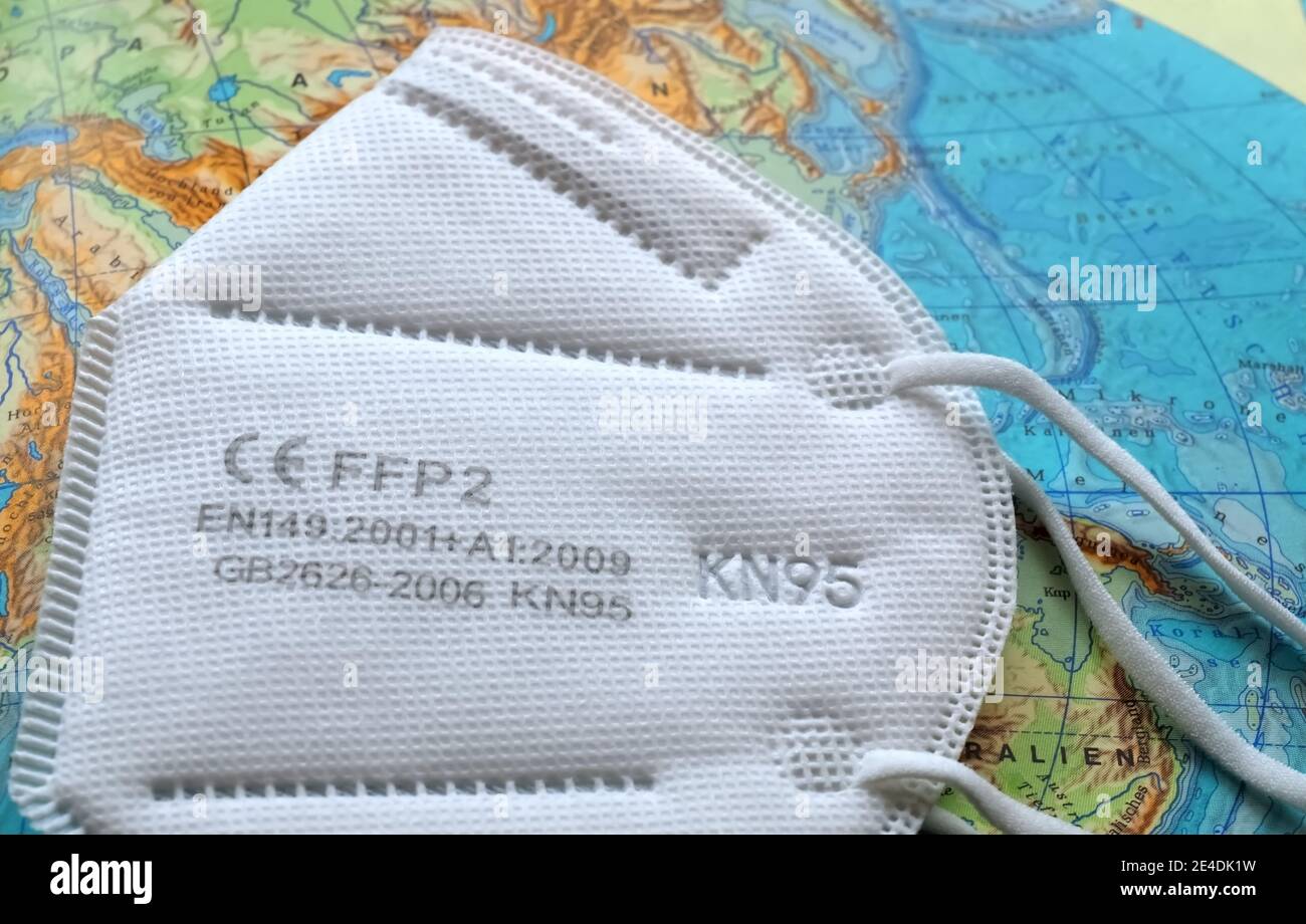 A single FFP2 face mask on a map as a symbol for flight restrictions ...