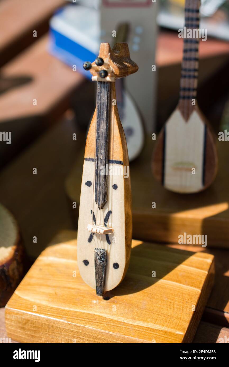 Vertical shot of a vintage violin on a wooden stand captured in an ...
