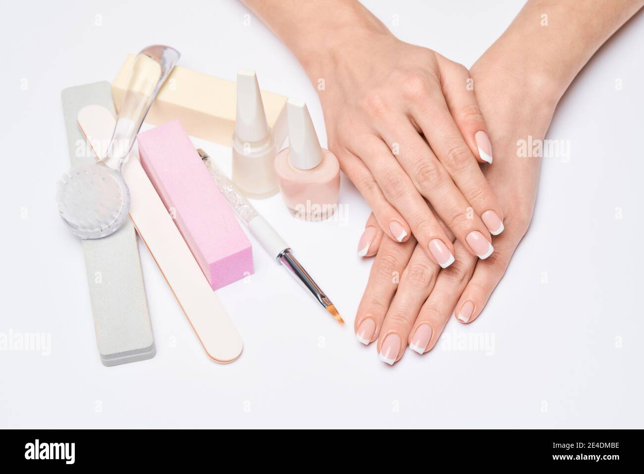 Beautiful Female Hands with French manicure over light grey background ...