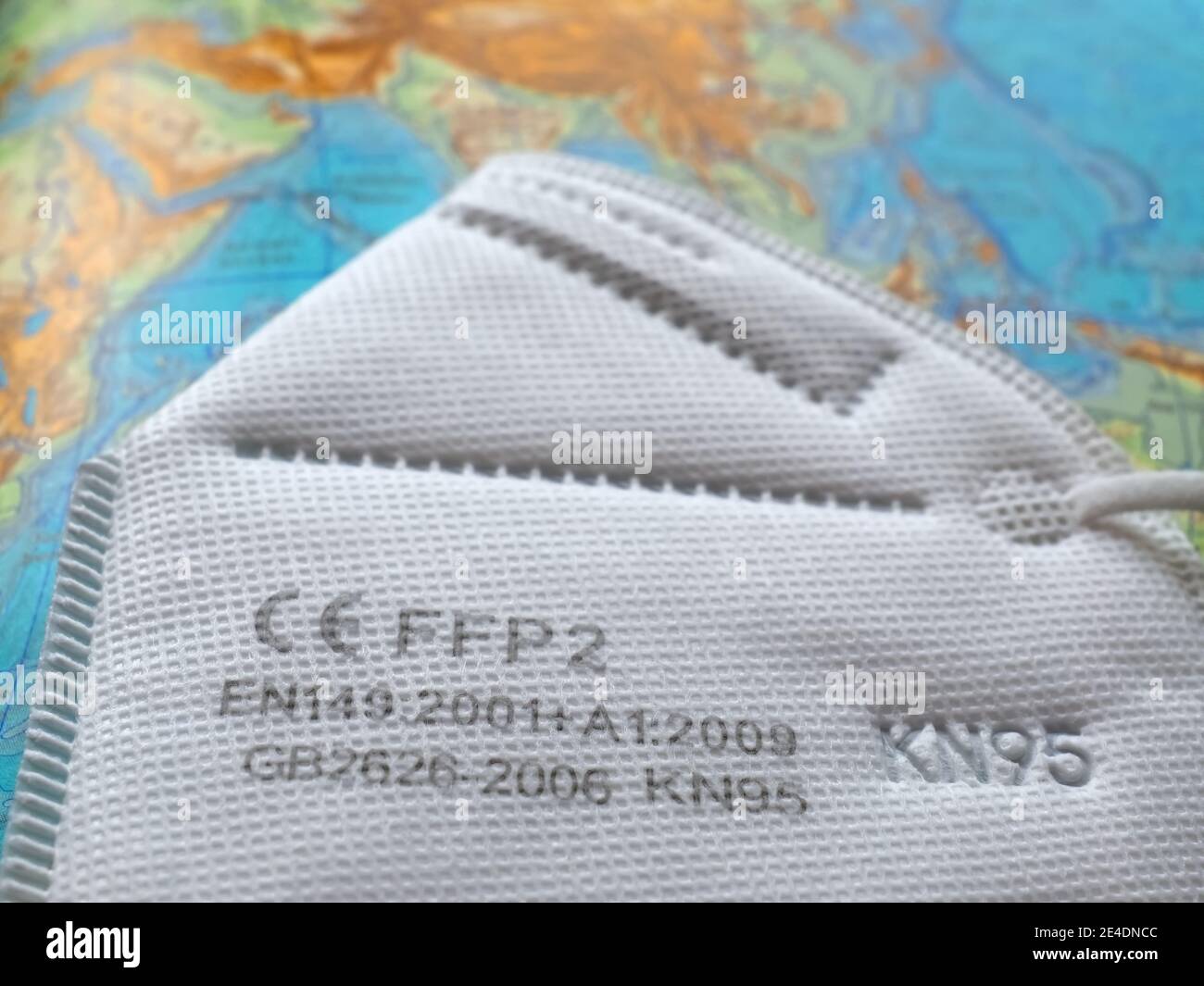 A single FFP2 face mask on a map as a symbol for flight restrictions ...