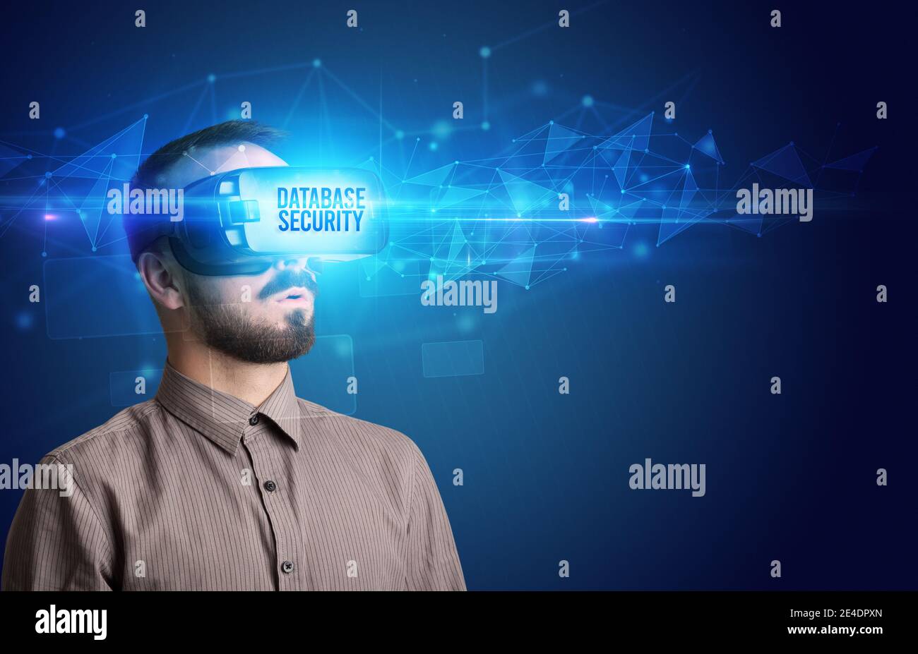 Businessman looking through Virtual Reality glasses with DATABASE ...