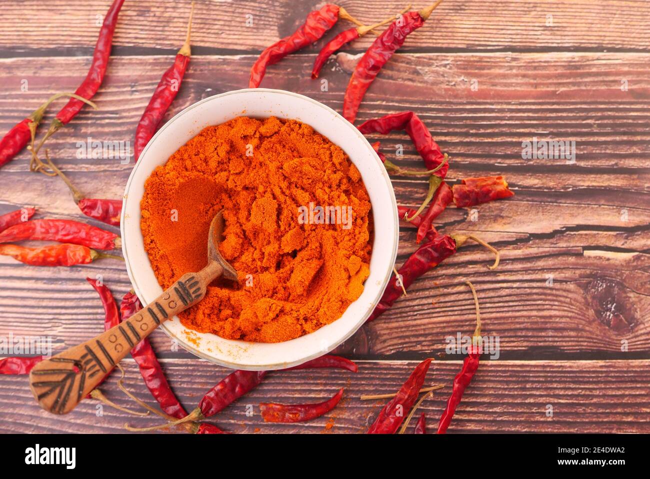 Chili powder and dried peppers on table background Stock Photo - Alamy