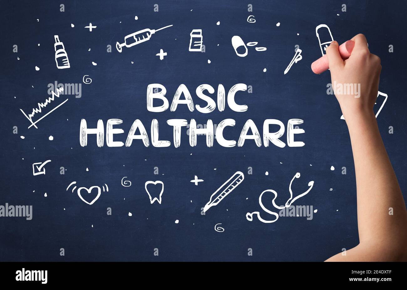 Hand drawing BASIC HEALTHCARE inscription with white chalk on ...