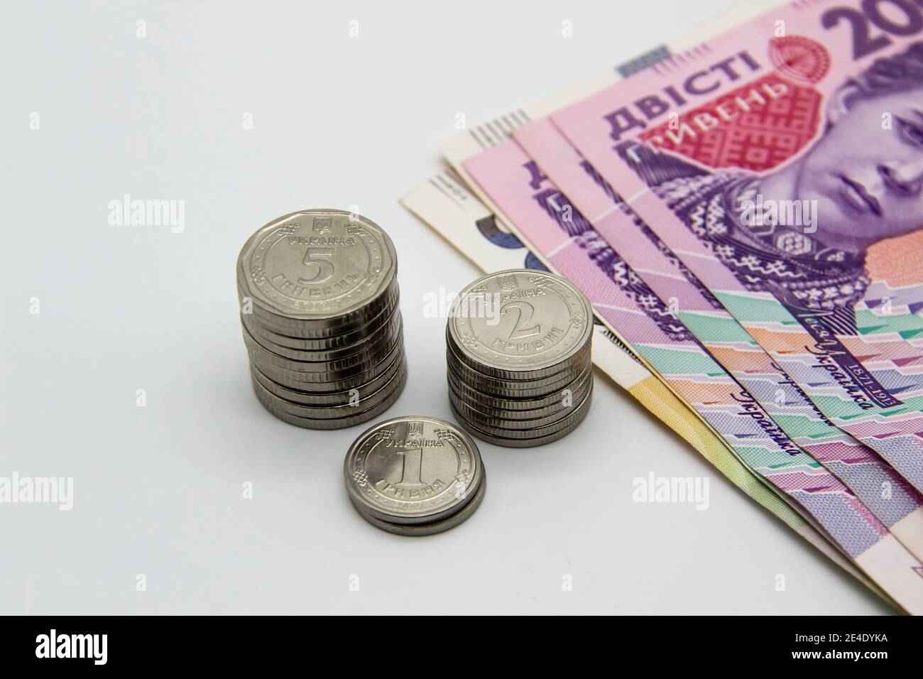 Ukrainian money on a light background. Banknotes and metal coins all ...