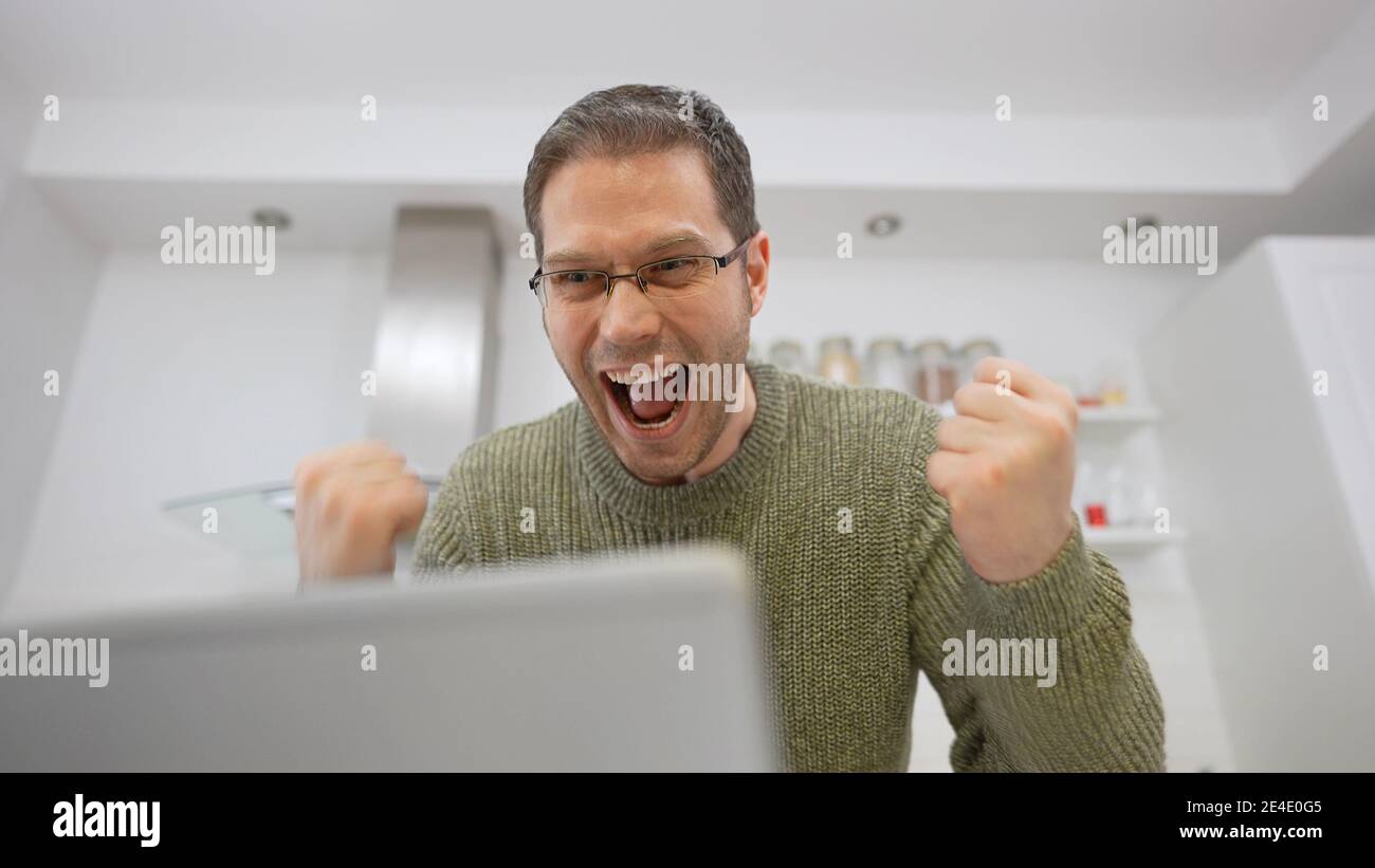 Excited man in front laptop hi-res stock photography and images - Alamy