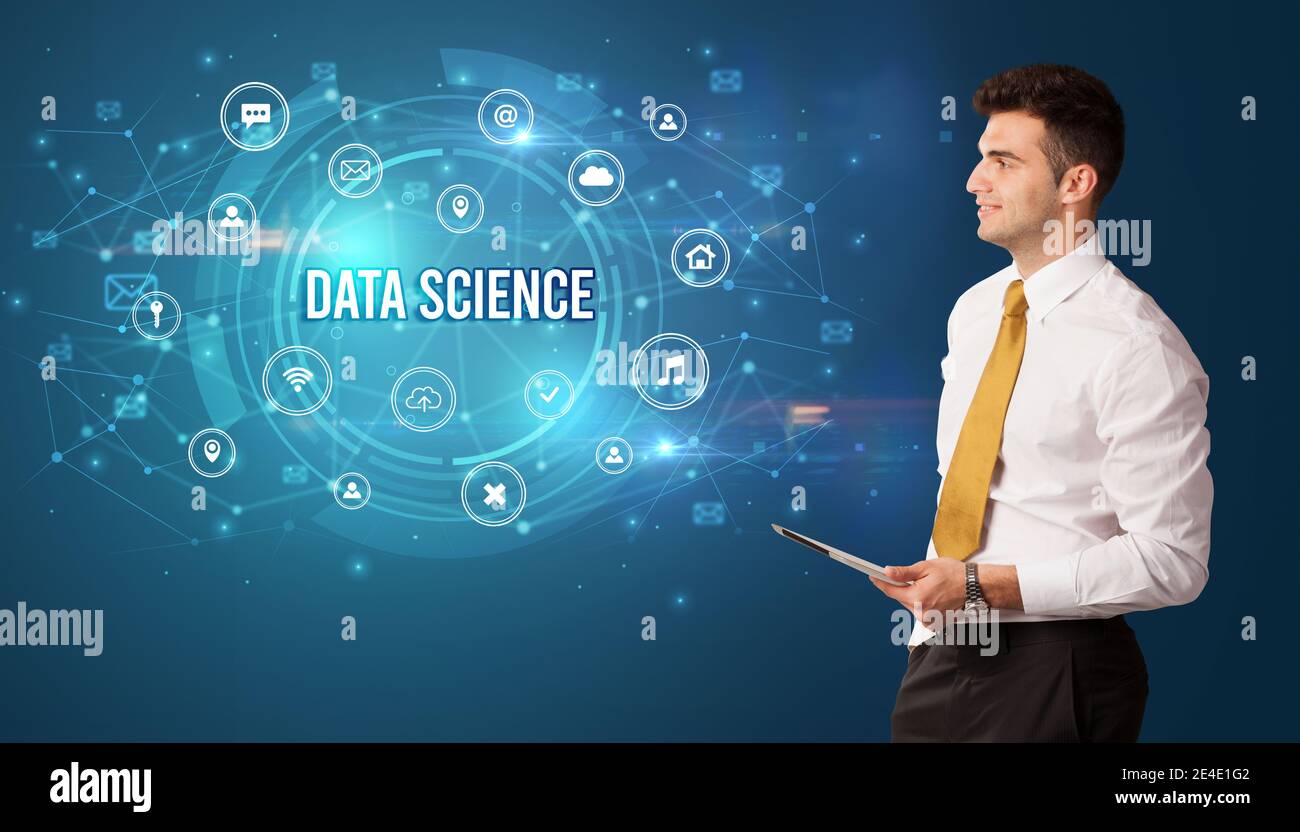 Businessman thinking in front of technology related icons and DATA ...