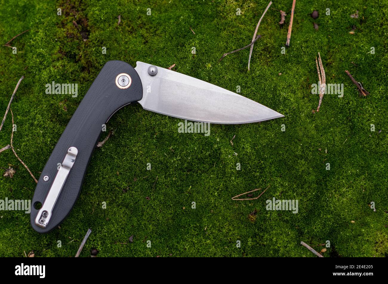 Reverse knife with a clip on the handle. Knife in a bent position on ...