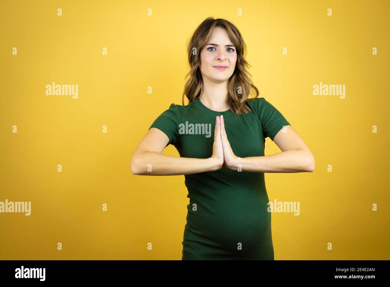 Young beautiful brunette woman pregnant expecting baby over isolated ...