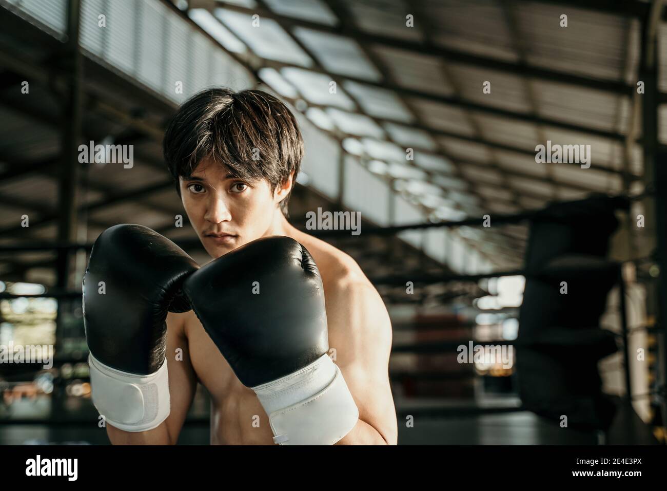 ultimate fighter in boxing gloves with movement hands defend beside ...