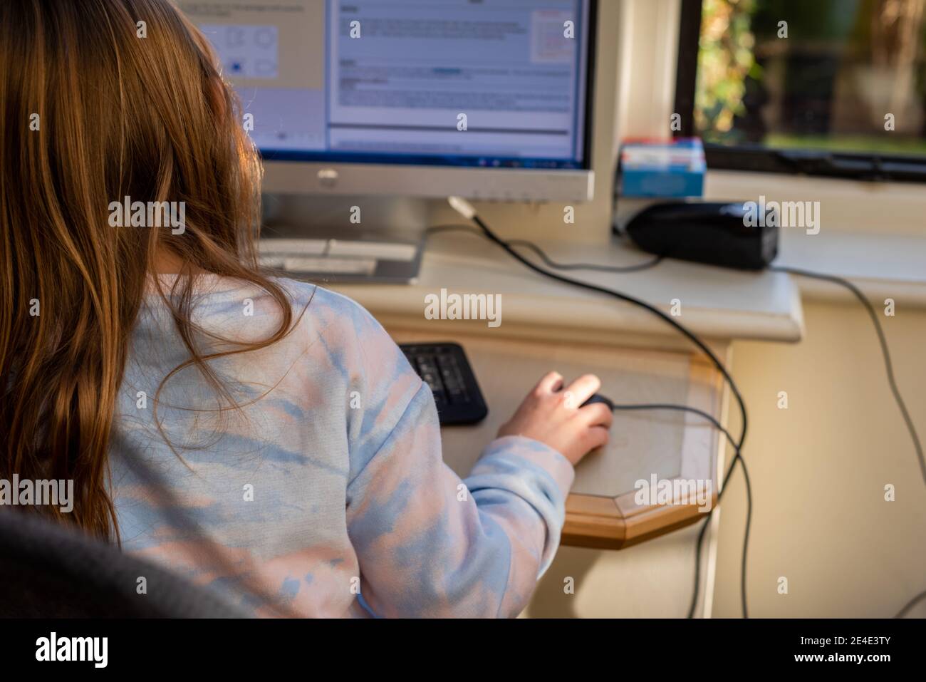 Child working at home during lockdown as children need to home school ...