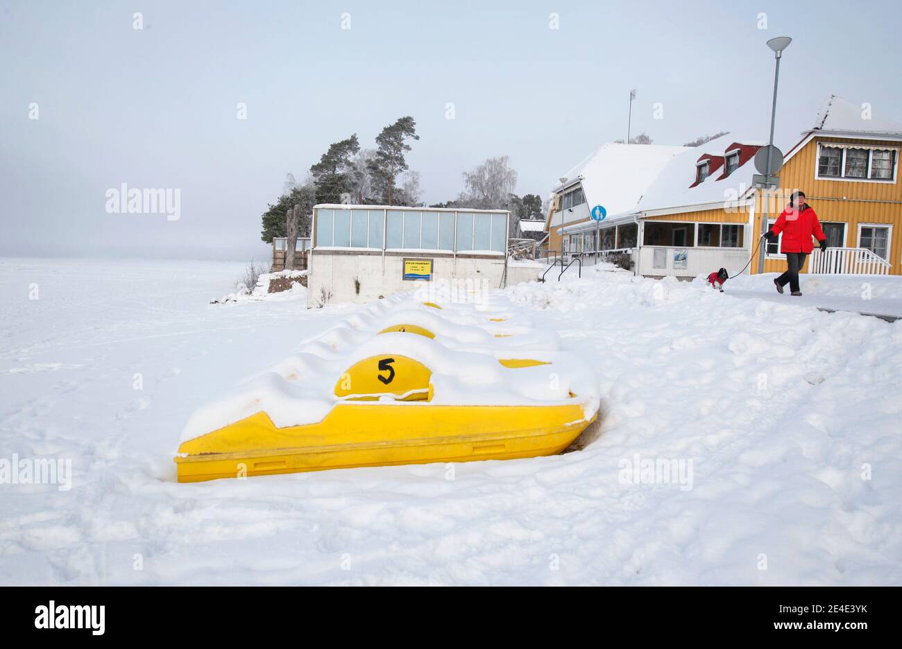 MOTALA, SWEDEN- 12 JANUARY 2010: Pedal boats pulled up on the beach, at ...