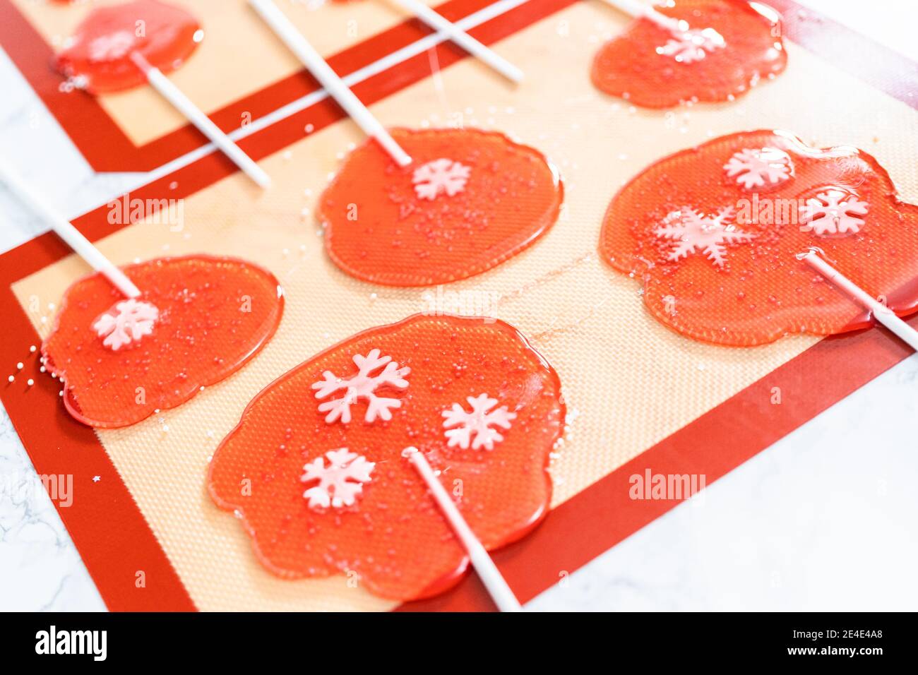 Making homemade berry flavor lollipops with snowflakes Stock Photo - Alamy