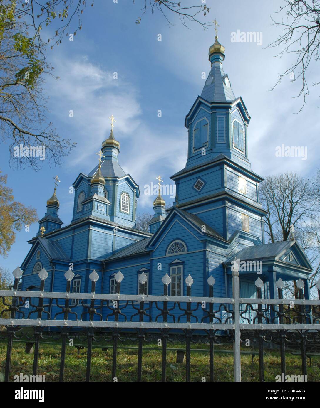 Church of Blessed Virgin Nativity oin Olyka. Blue sky, yellow leaves ...