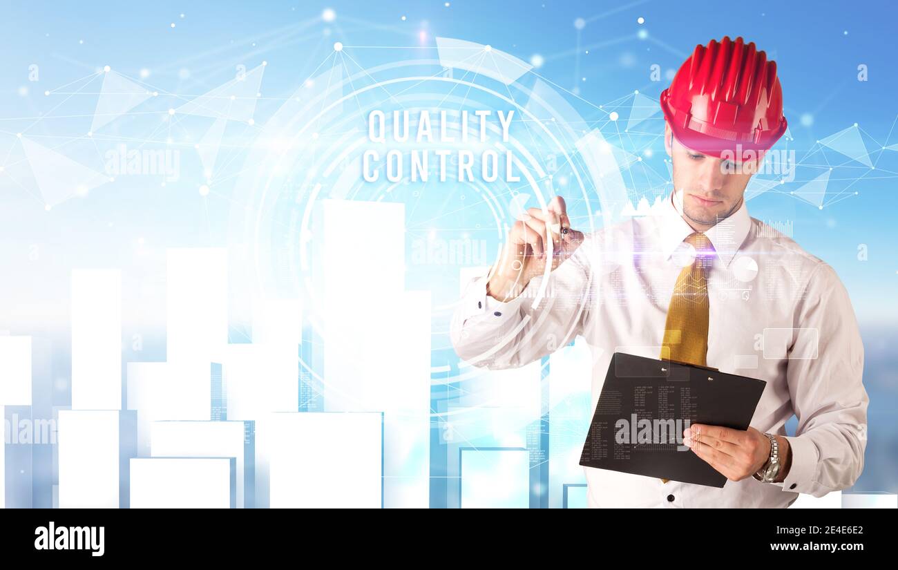 Handsome businessman with helmet drawing QUALITY CONTROL inscription ...