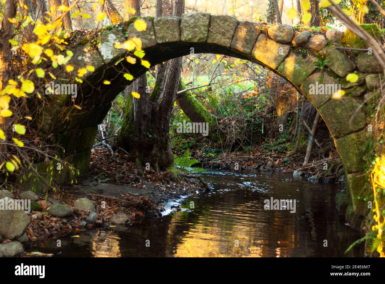Old stone block bridge over the Balozano river in autumn horizontally ...