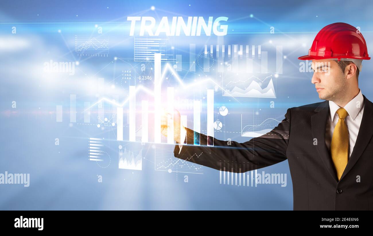 Handsome businessman with helmet drawing TRAINING inscription ...
