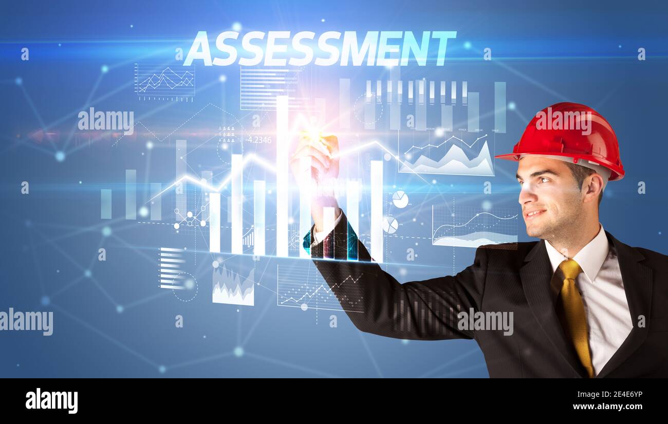 Handsome businessman with helmet drawing ASSESSMENT inscription ...