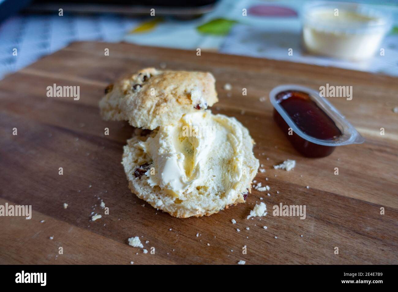 Scone with clotted cream first then jam Stock Photo - Alamy