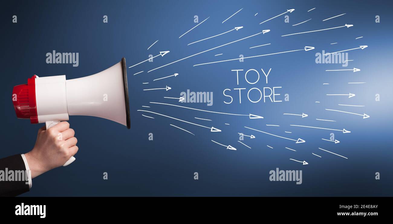 Young girl screaming to megaphone with TOY STORE inscription, shopping ...