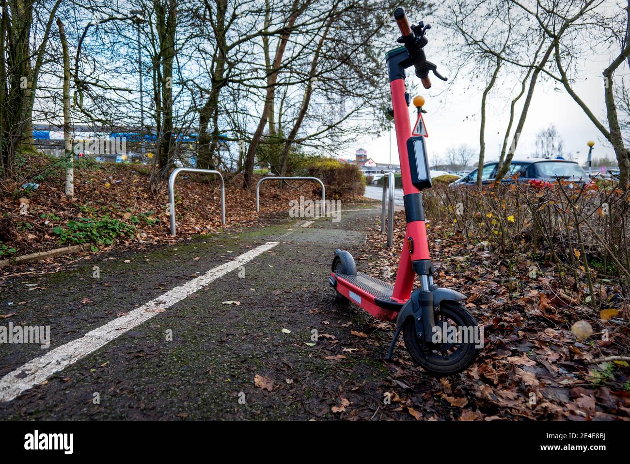 Battery powered electric scooter vehicle left on pedestrian footpath ...