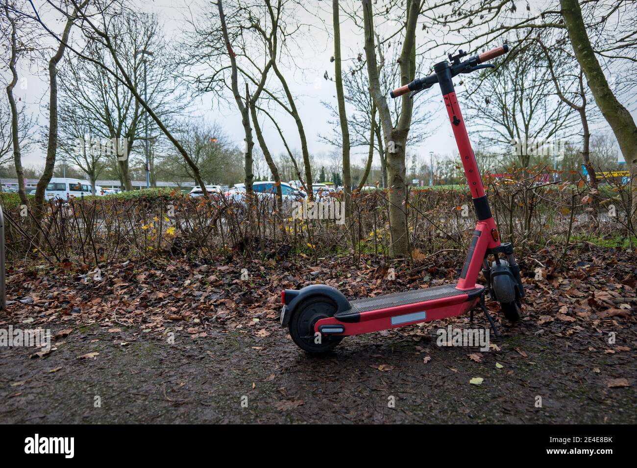 Battery powered electric scooter vehicle left on pedestrian footpath ...