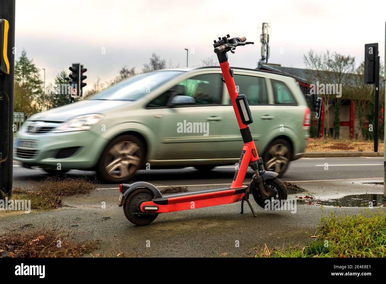 Battery powered electric scooter vehicle left on pedestrian footpath ...
