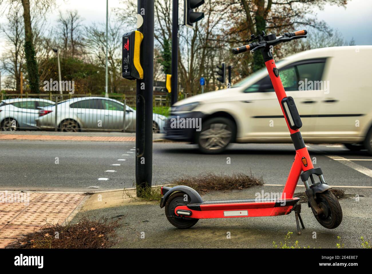 Battery powered electric scooter vehicle left on pedestrian footpath ...