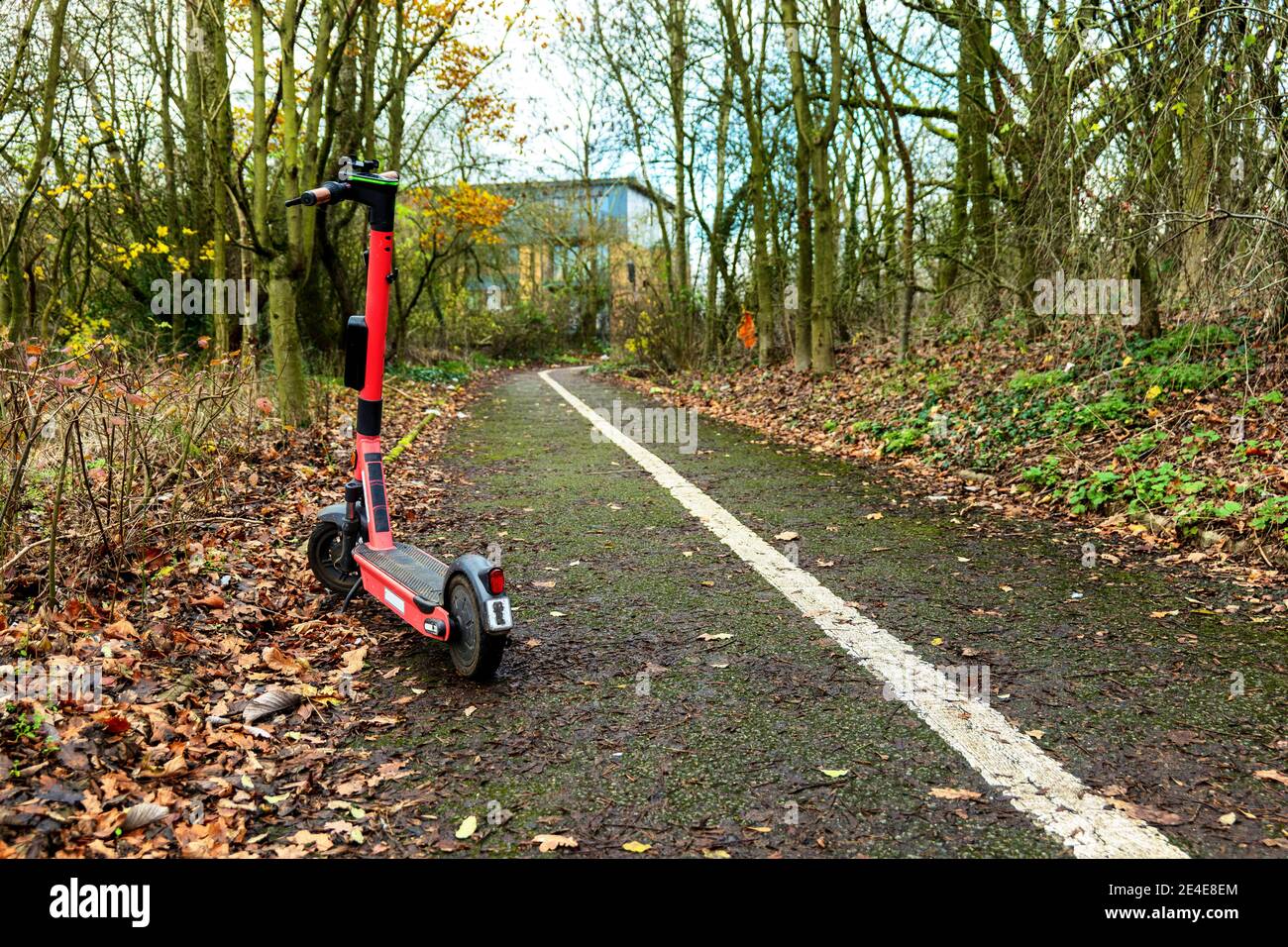 Battery powered electric scooter vehicle left on pedestrian footpath ...