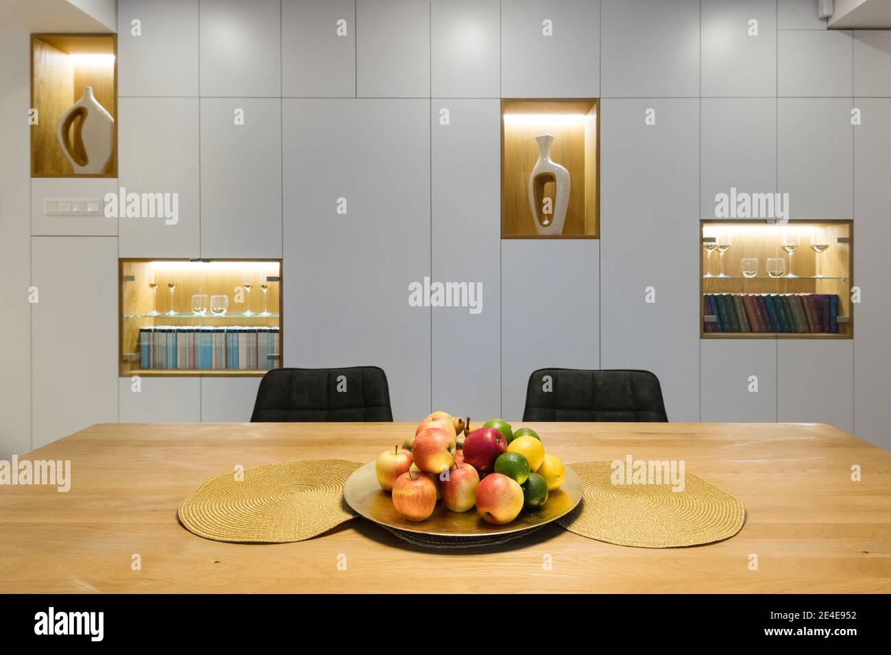 Dining table with fruit basket in modern house Stock Photo - Alamy