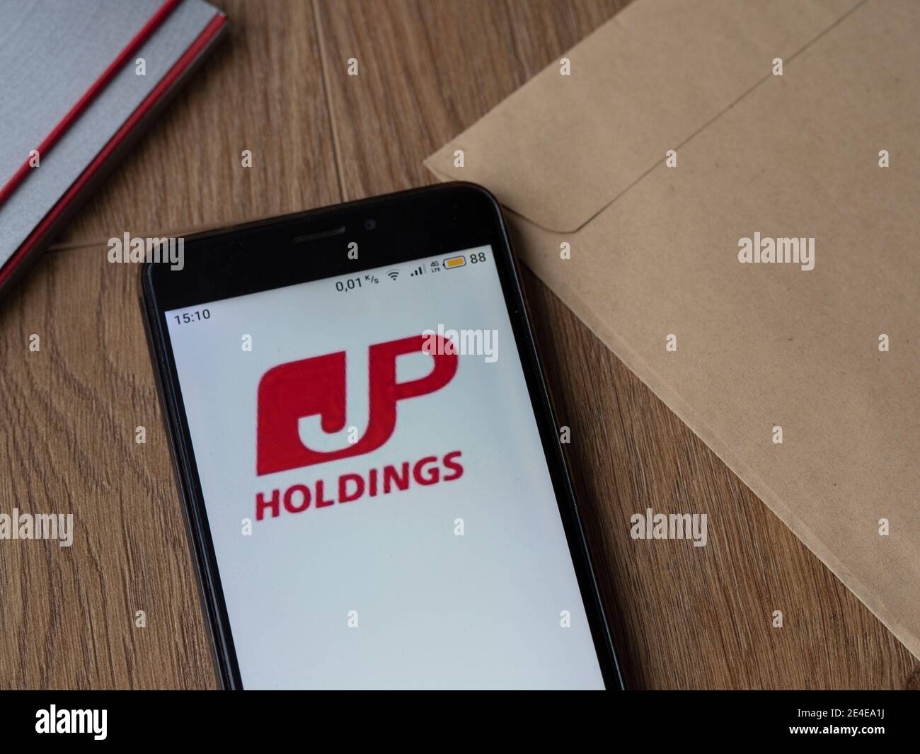 In this photo illustration a Japan Post Holdings logo seen displayed on ...