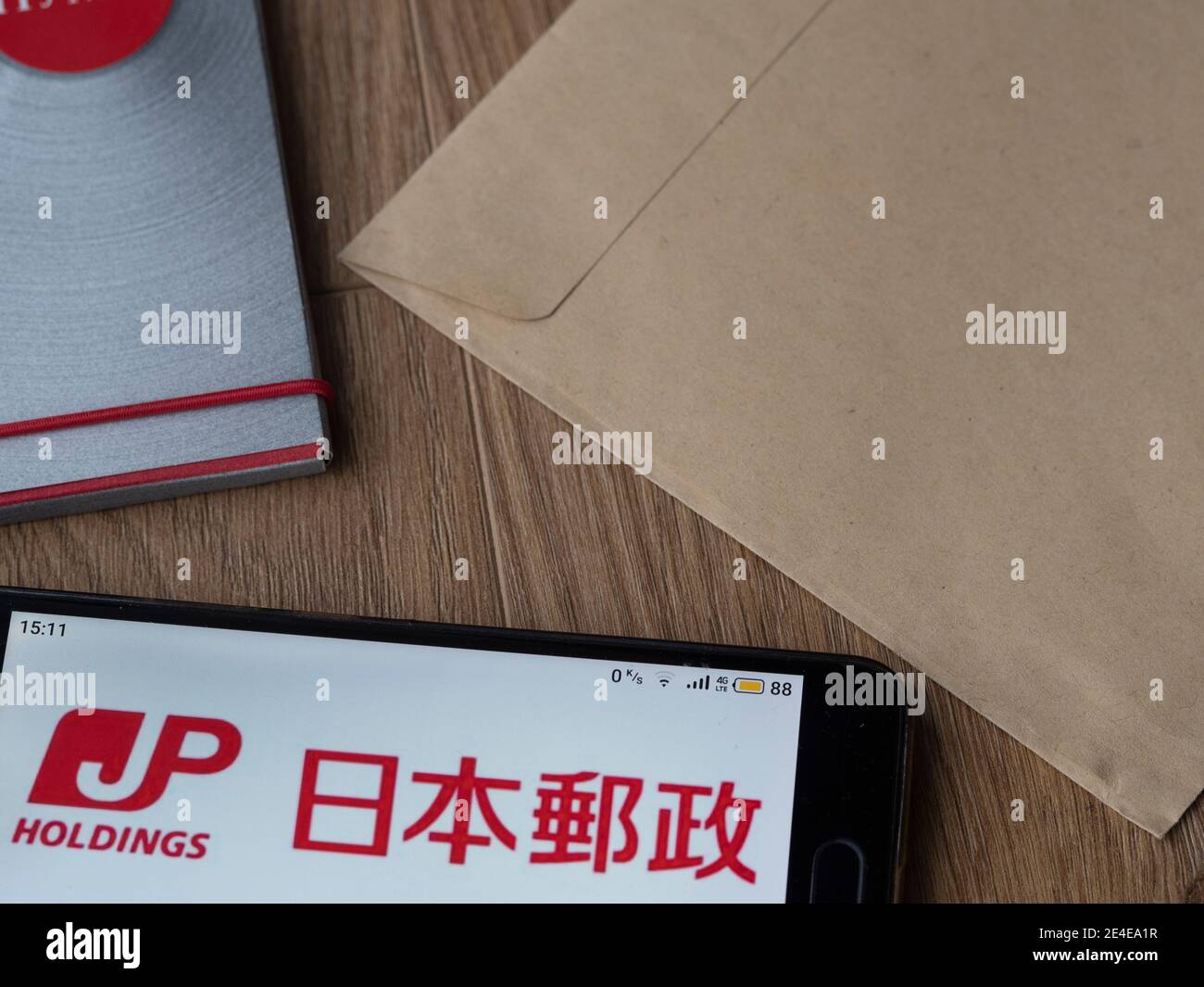 In this photo illustration a Japan Post Holdings logo seen displayed on ...