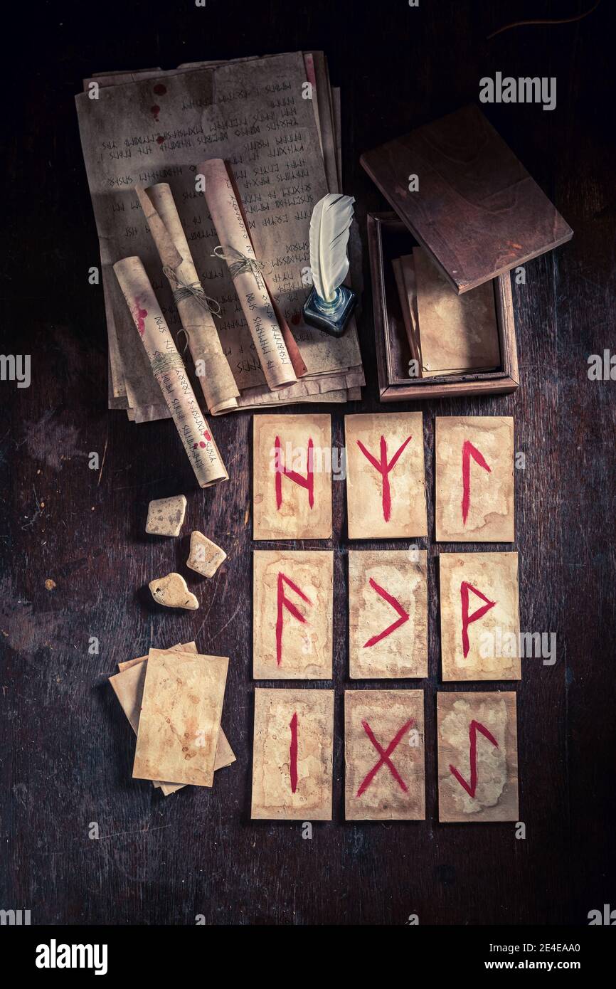 Unique fortune teller from futhark rune cards and runestones on wooden ...