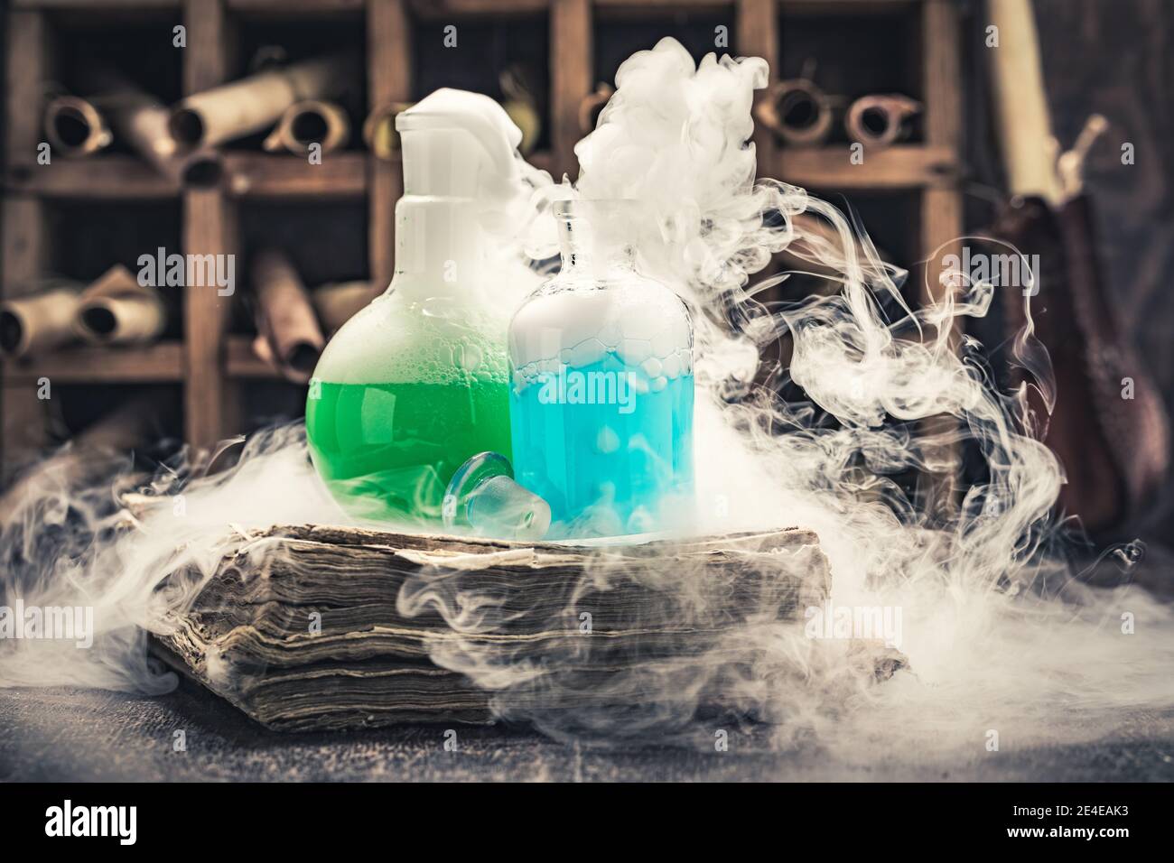 Vintage alchemist laboratory with chemical flask and manuscripts on ...