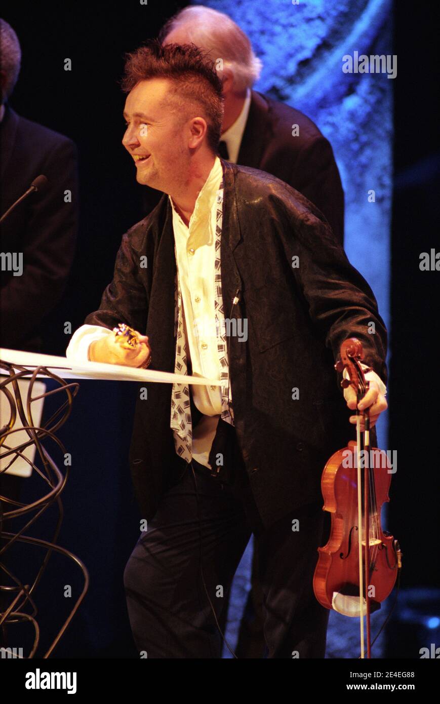 Nigel Kennedy collects his award on stage at The Classical Brit Awards ...