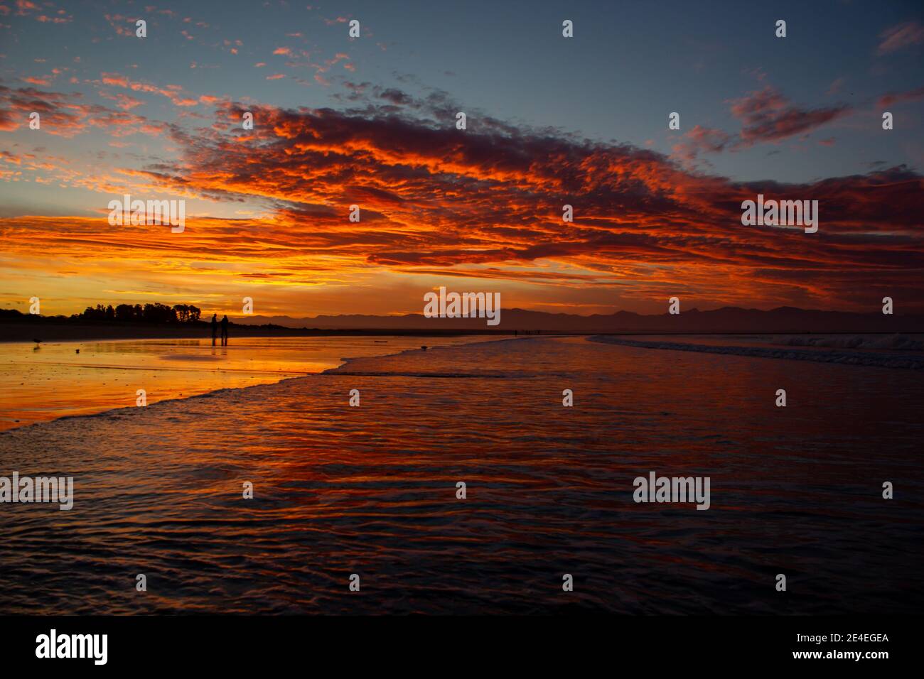 Beach in Nelson during a breathtaking sunset on Tahunanui Beach at ...