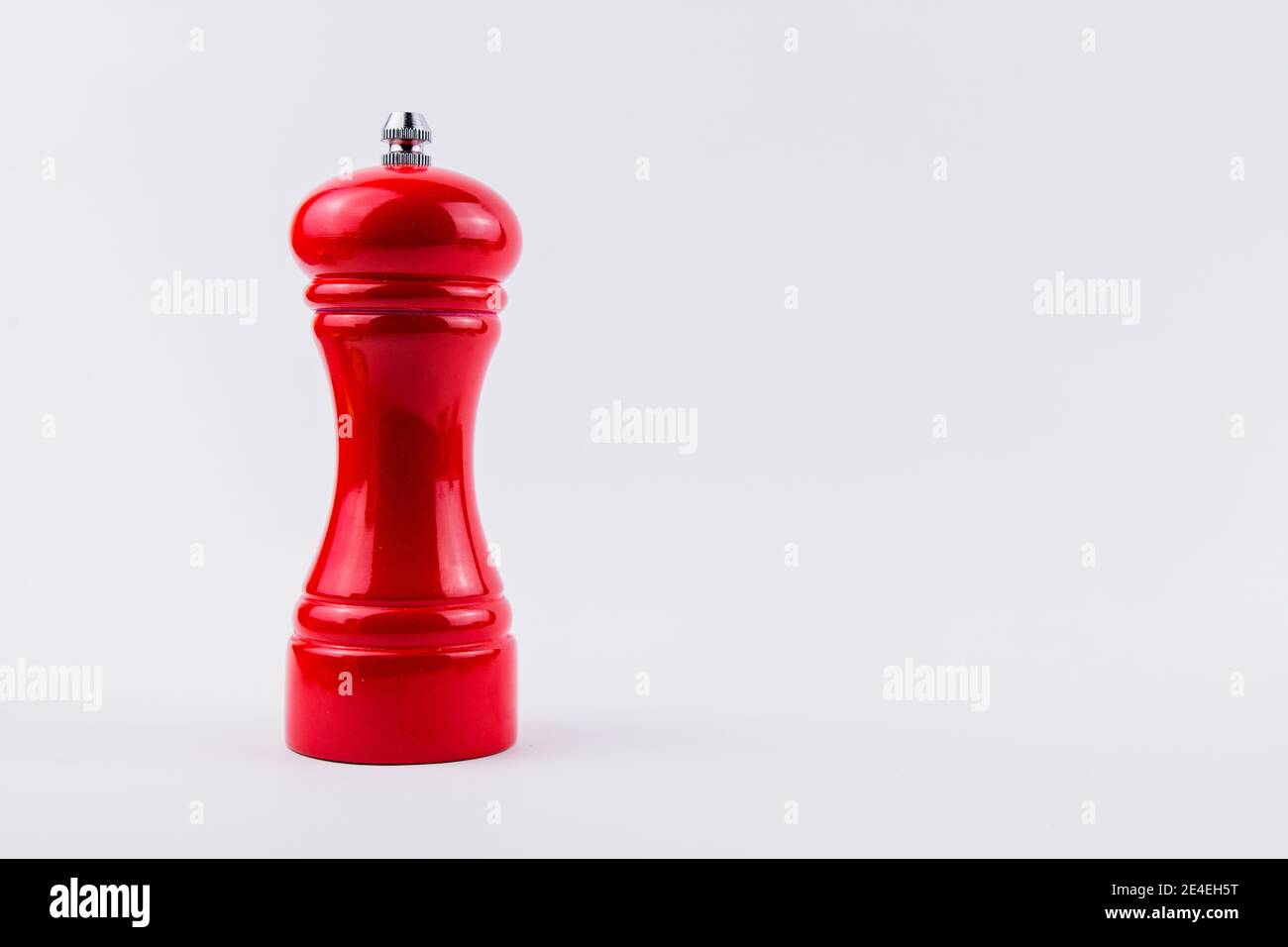 a red pepper shaker on white background Stock Photo - Alamy
