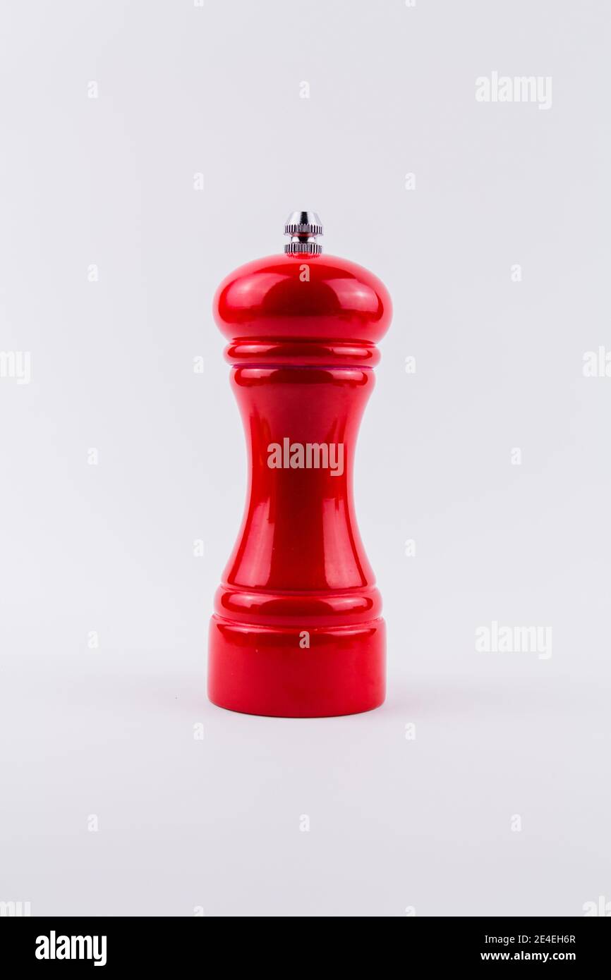 a red pepper shaker on white background Stock Photo - Alamy