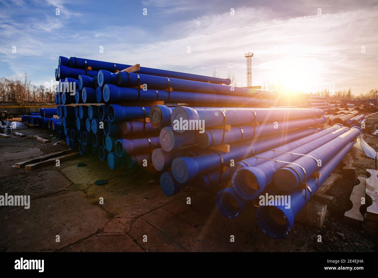 Stack of cast iron pipes in loading area waiting for transportation ...
