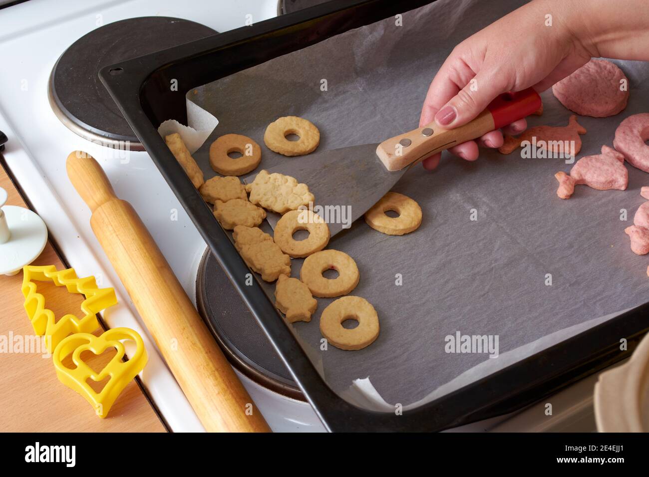 Cutting cookies from the dough and preparing for bake in the electrical ...