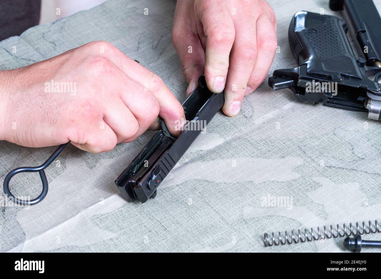 Cleaning the receiver of the pistol. Cleaning the pistol with a rag ...