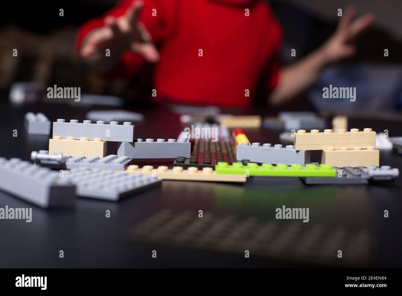 Child building with Lego. Hand of child reaching a brick from ...