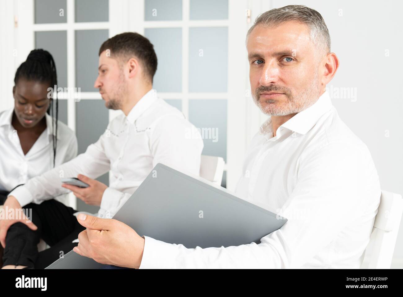 Portrait of confident male entrepreneur holding modern touch pad in ...