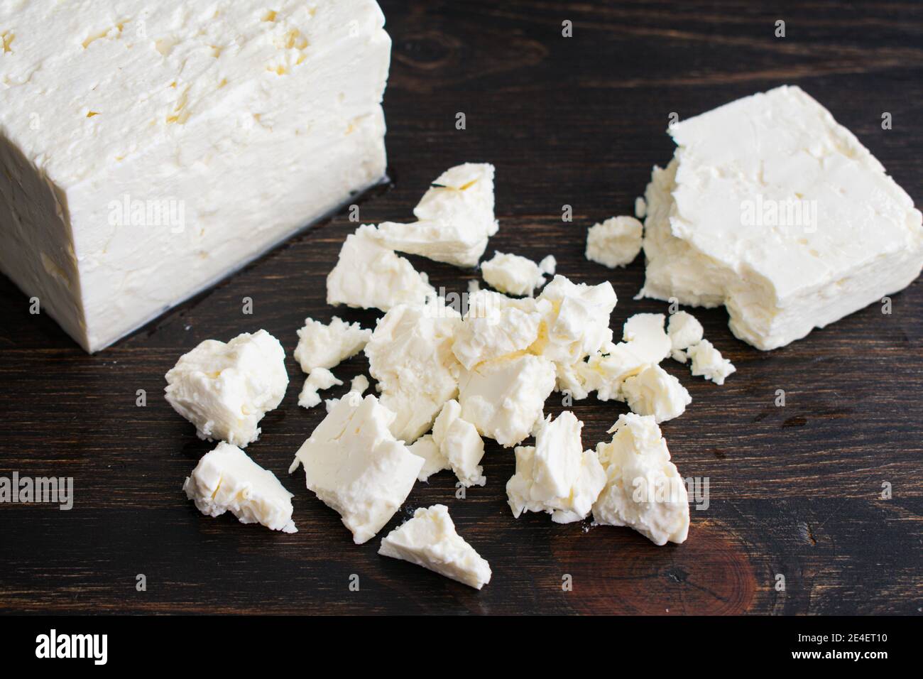 Crumbling a Block of Feta Cheese: A block of feta cheese that has been ...