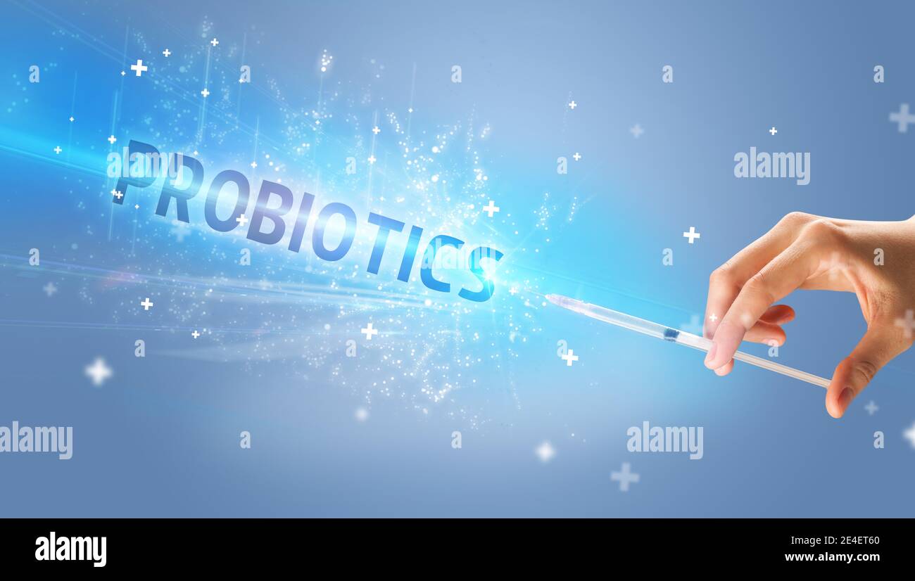 Syringe, medical injection in hand with PROBIOTICS inscription, medical ...