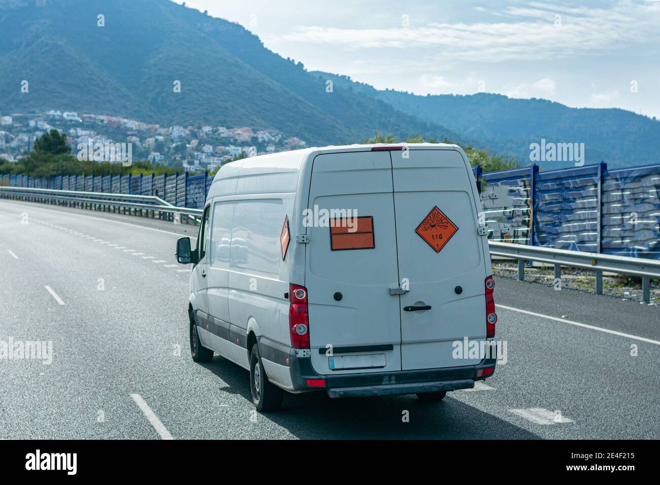 Van transporting explosives, with orange panel and danger labels for ...