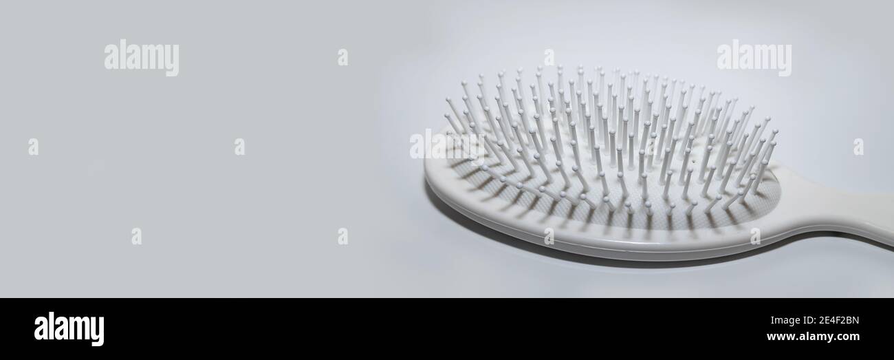 Close-up of white hairbrush on white background Stock Photo - Alamy